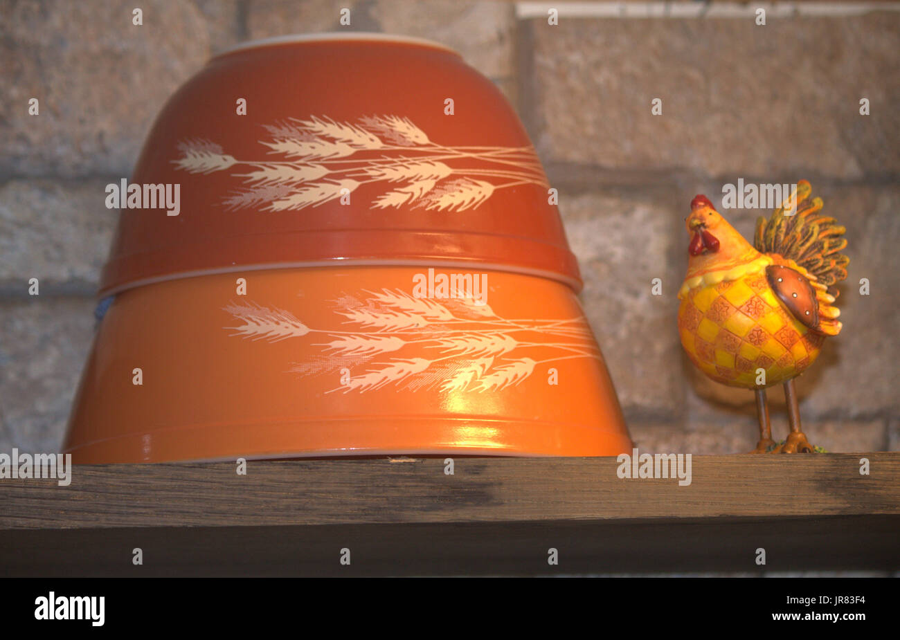 Two stacked Pyrex Bowls in fall colors with a chicken beside them Stock ...