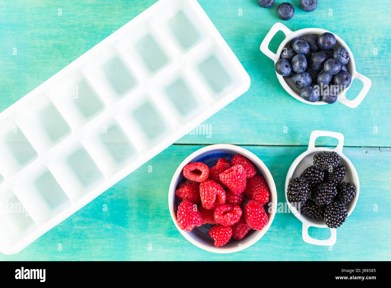 Making fresh fruit ice cubes for summer drink Stock Photo - Alamy