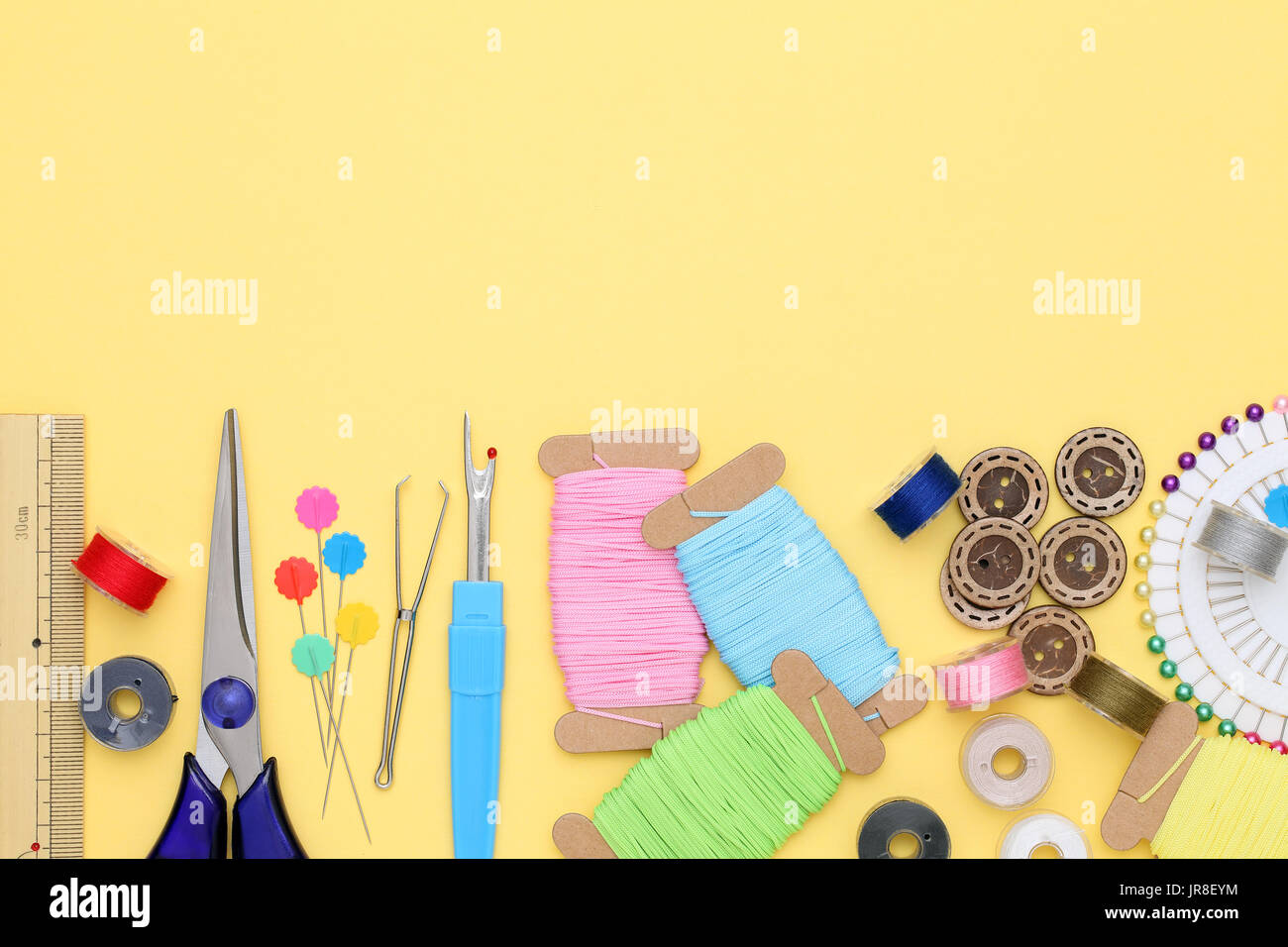 sewing tools, tailoring and fashion concept - close-up on yellow ...