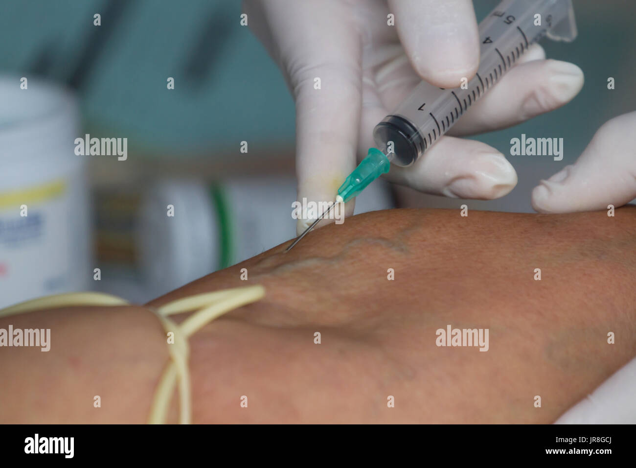 Close-up Of Doctor Injecting Patient With Syringe To Collect Blood ...