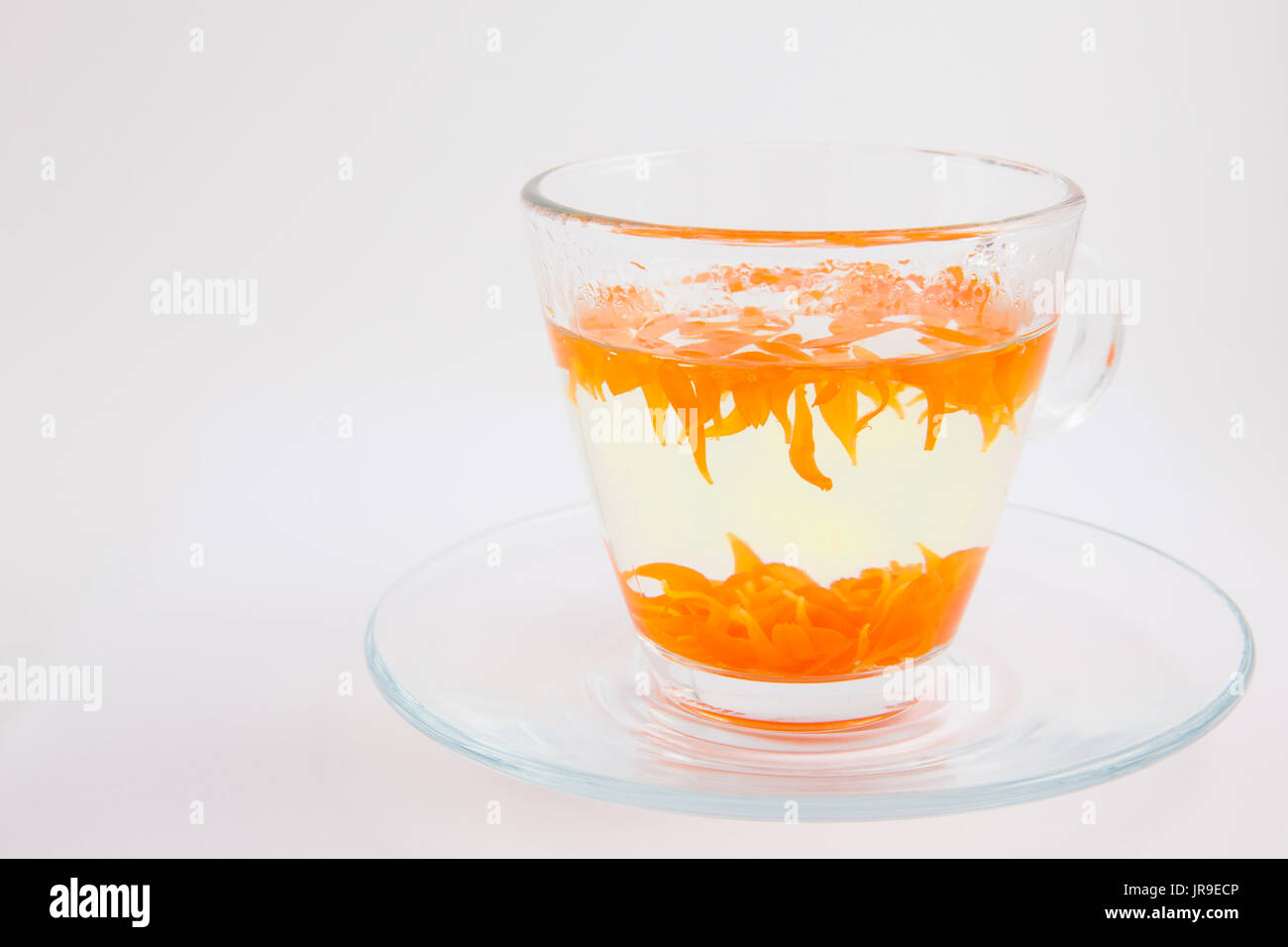 Orange pot marigold (Calendula officinalis) flower infusion Stock Photo ...