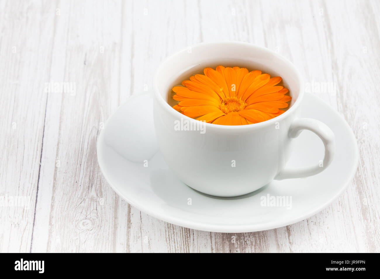 Orange pot marigold (Calendula officinalis) flower infusion Stock Photo ...