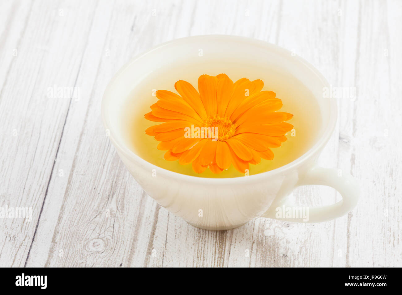 Orange pot marigold (Calendula officinalis) flower infusion Stock Photo ...