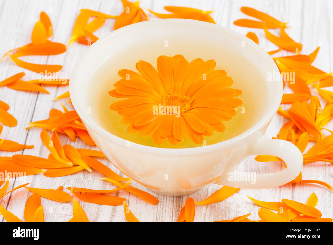 Orange pot marigold (Calendula officinalis) flower infusion Stock Photo ...