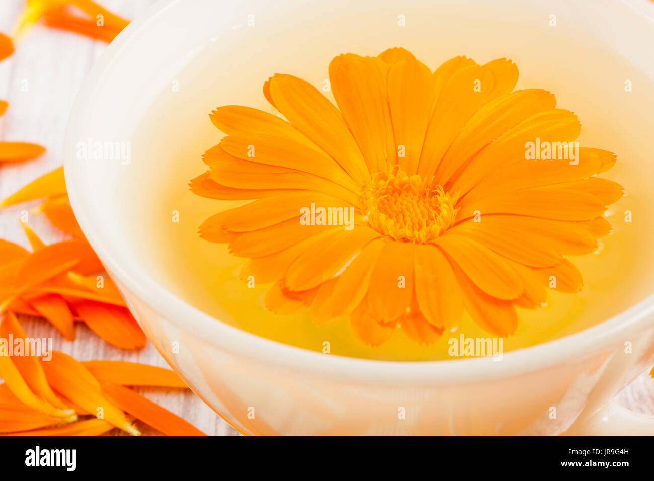 Orange pot marigold (Calendula officinalis) flower infusion Stock Photo ...