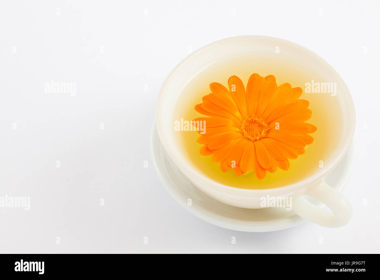 Orange pot marigold (Calendula officinalis) flower infusion Stock Photo ...