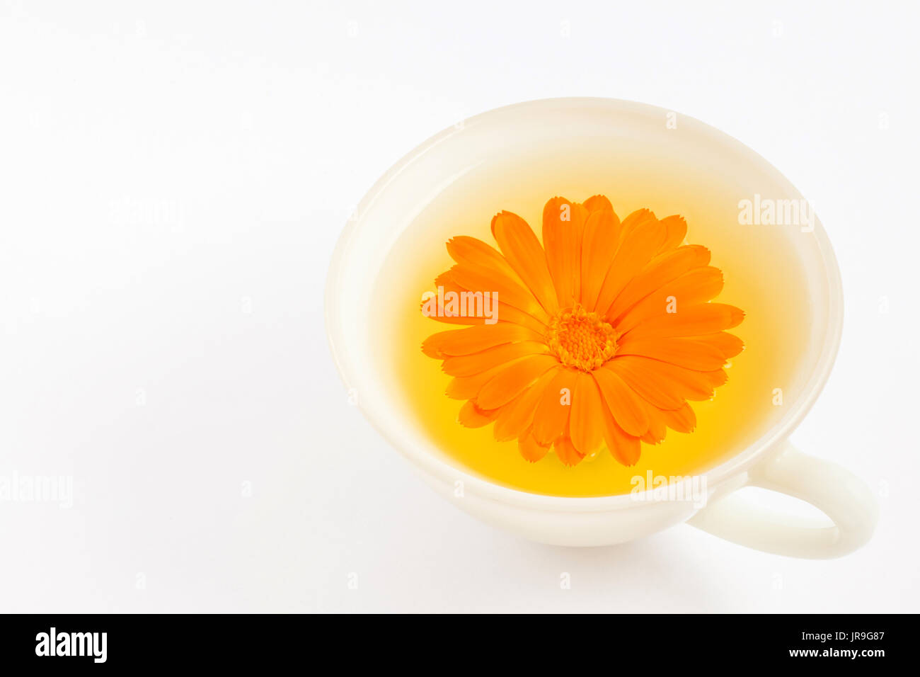 Orange pot marigold (Calendula officinalis) flower infusion Stock Photo ...