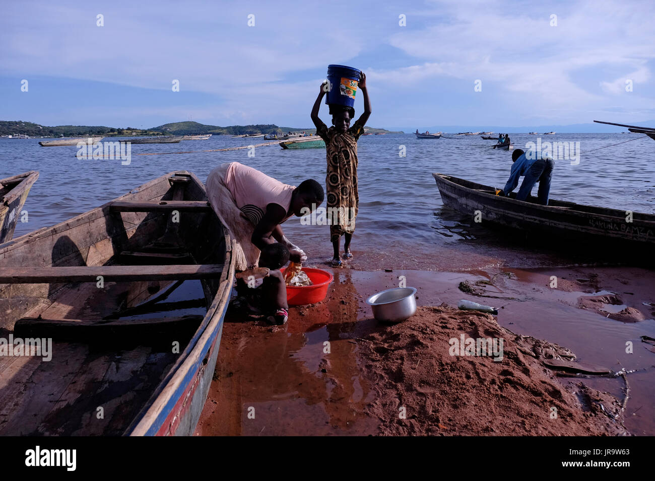 A woman washing clothes at the shore of Kibirizi fishing village in ...