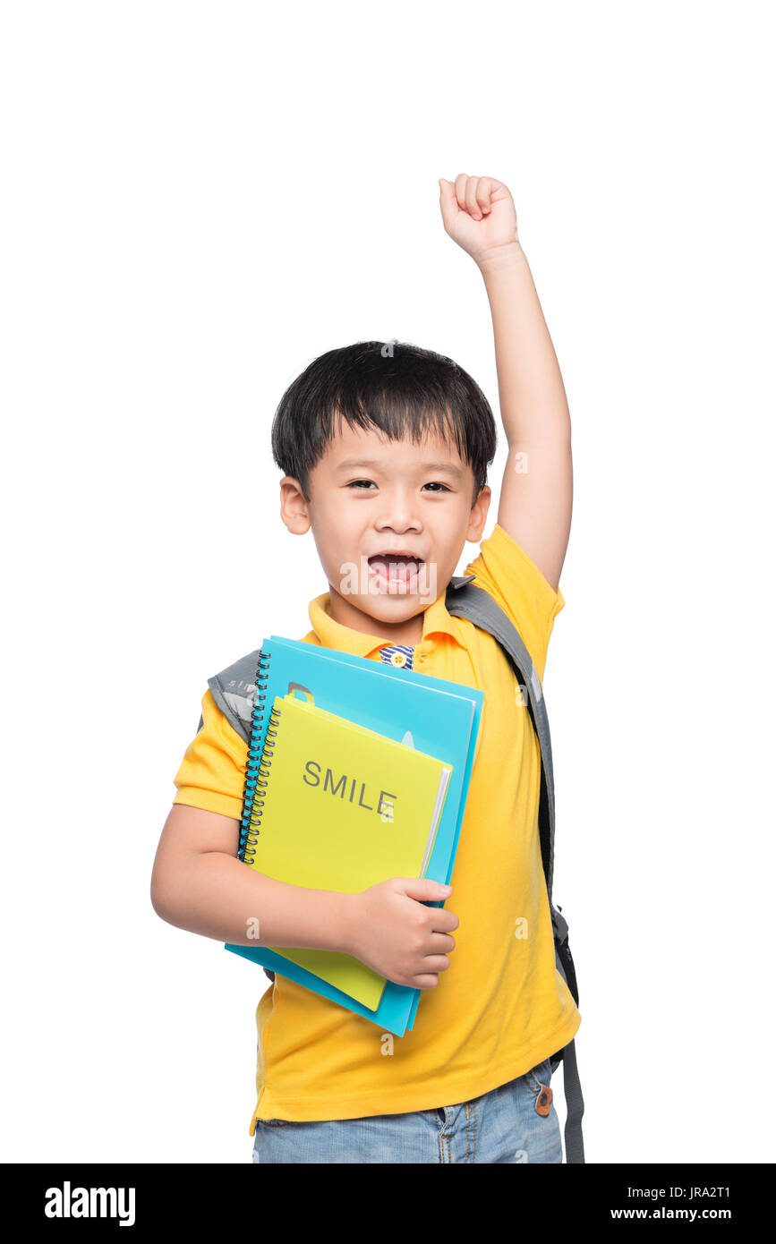 Portrait of cute smiling boy with backpack and colorful books with hand ...