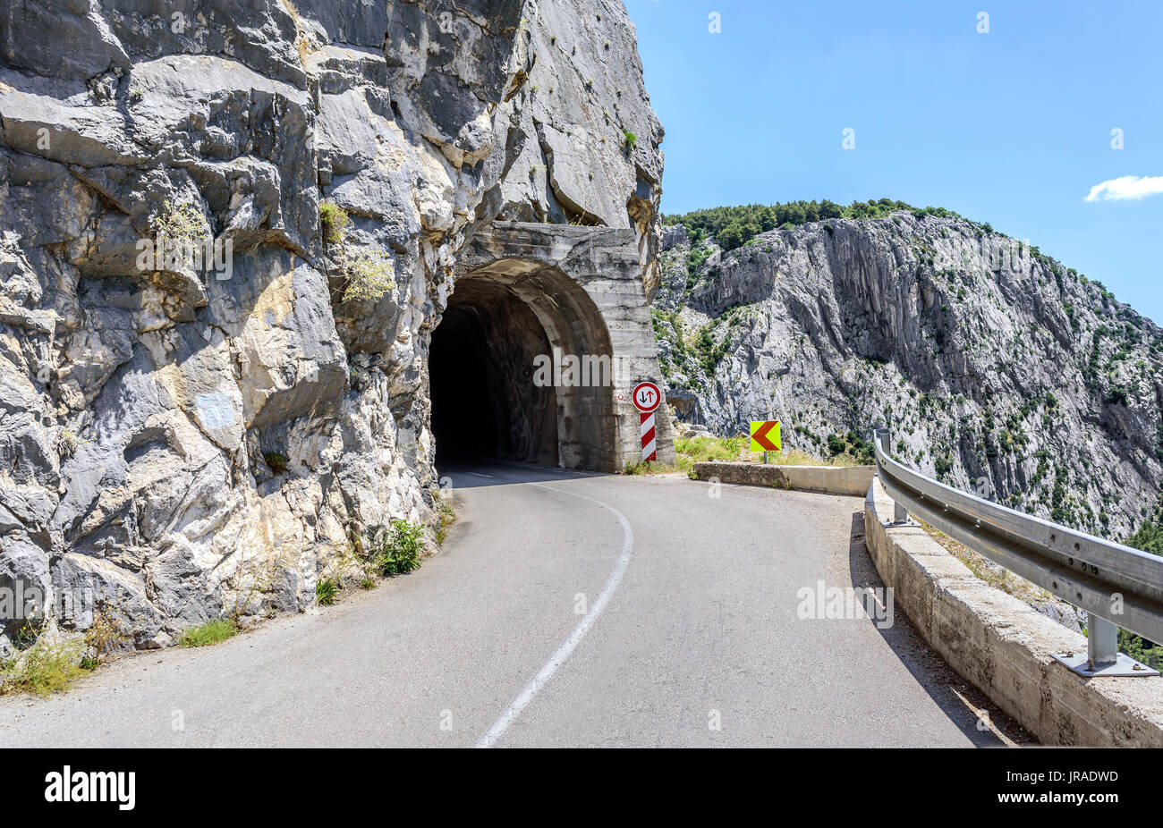 Asphalted mountain road with sharp turn near the cliff Stock Photo - Alamy