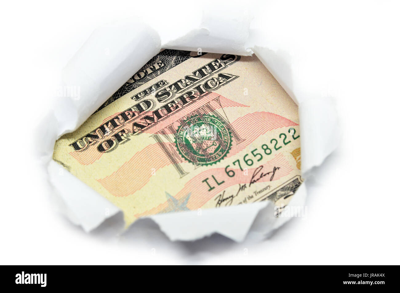 US currency macro peeking through torn white paper Stock Photo - Alamy