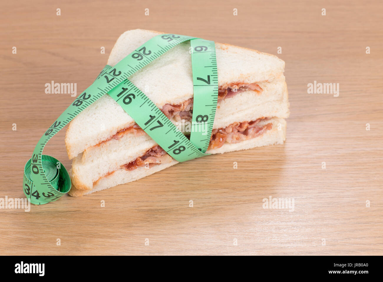 High angle view of meat sandwich wrapped in measuring tape Stock Photo ...
