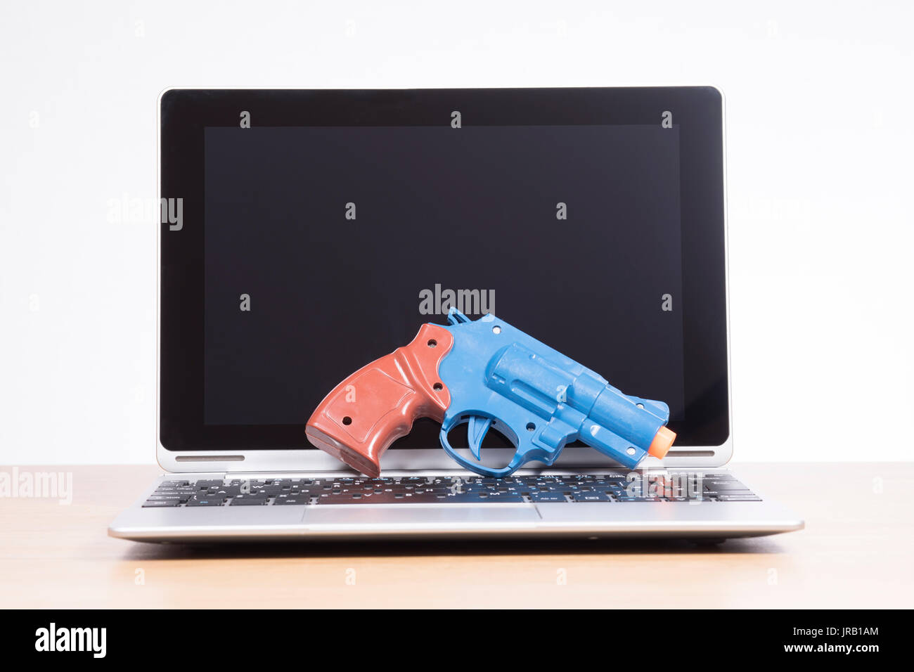 Crime internet laptop pistol hi-res stock photography and images - Alamy