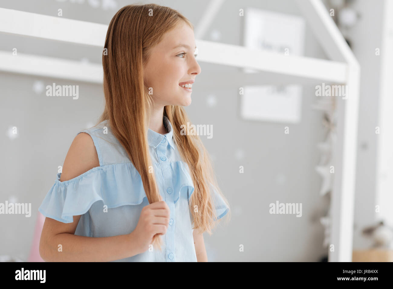 Radiant long haired young lady dreaming Stock Photo - Alamy