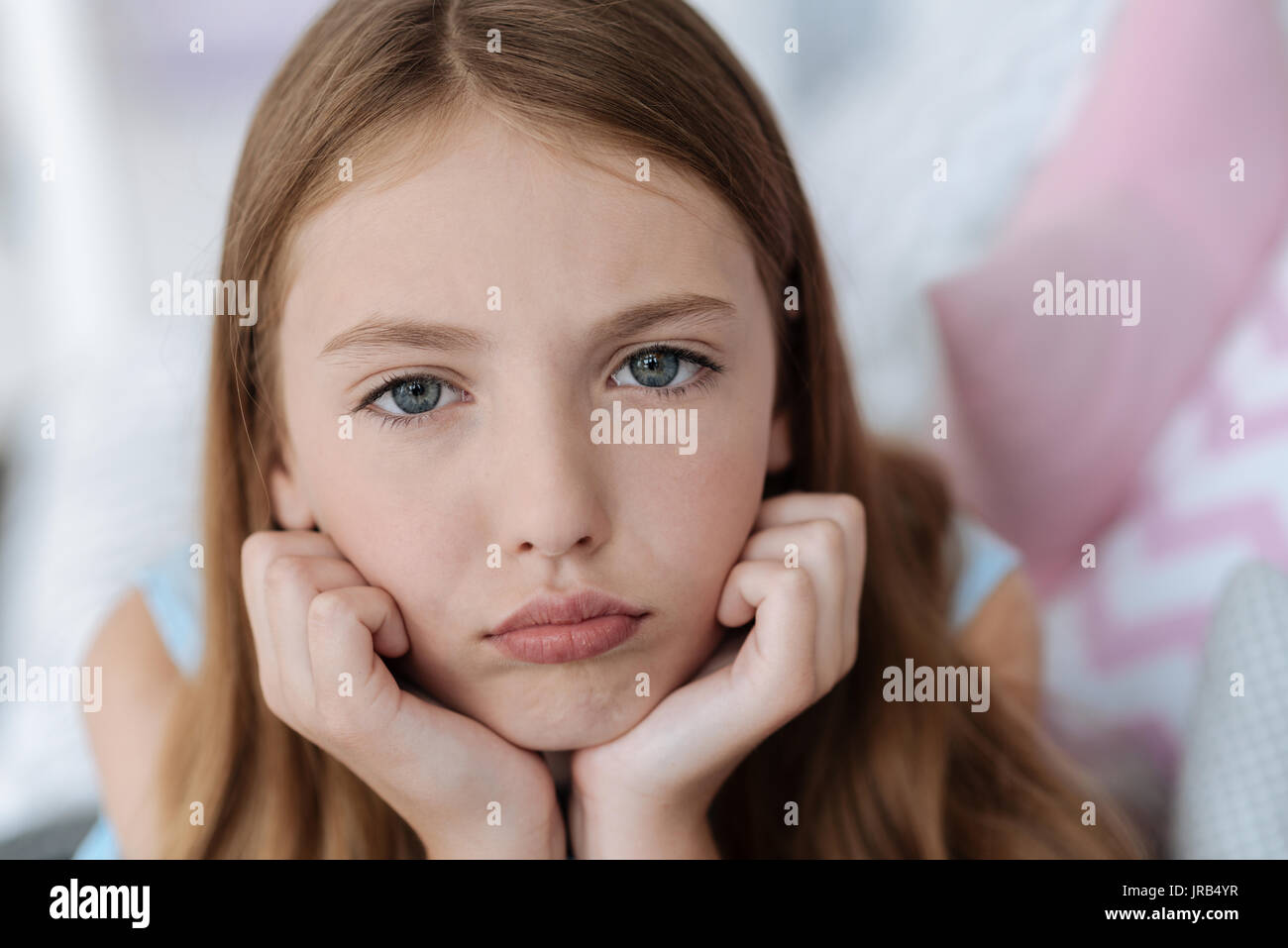 Sad young lady looking into the camera Stock Photo - Alamy