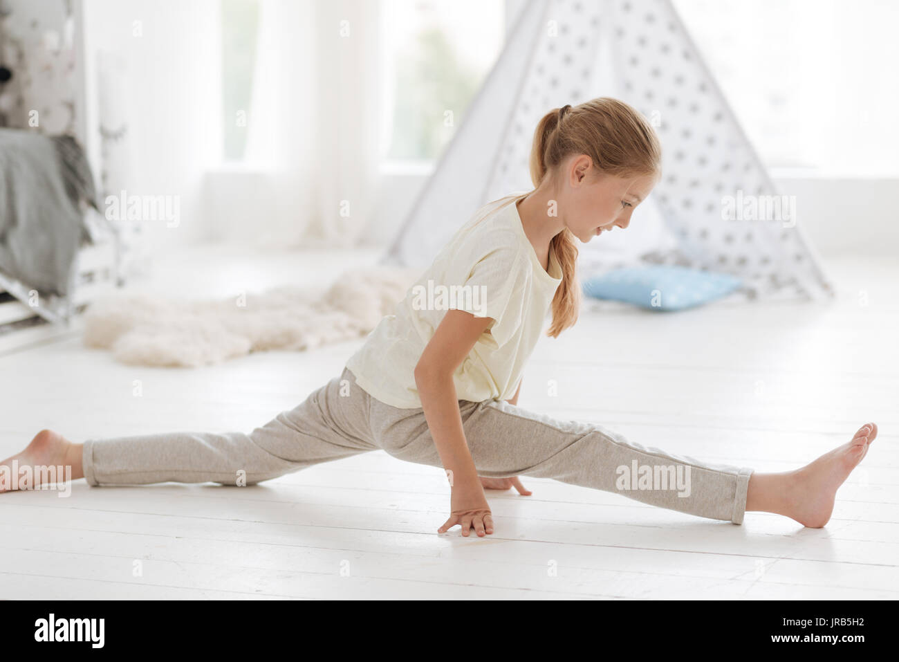 Real young sportsmen doing splits at home Stock Photo - Alamy