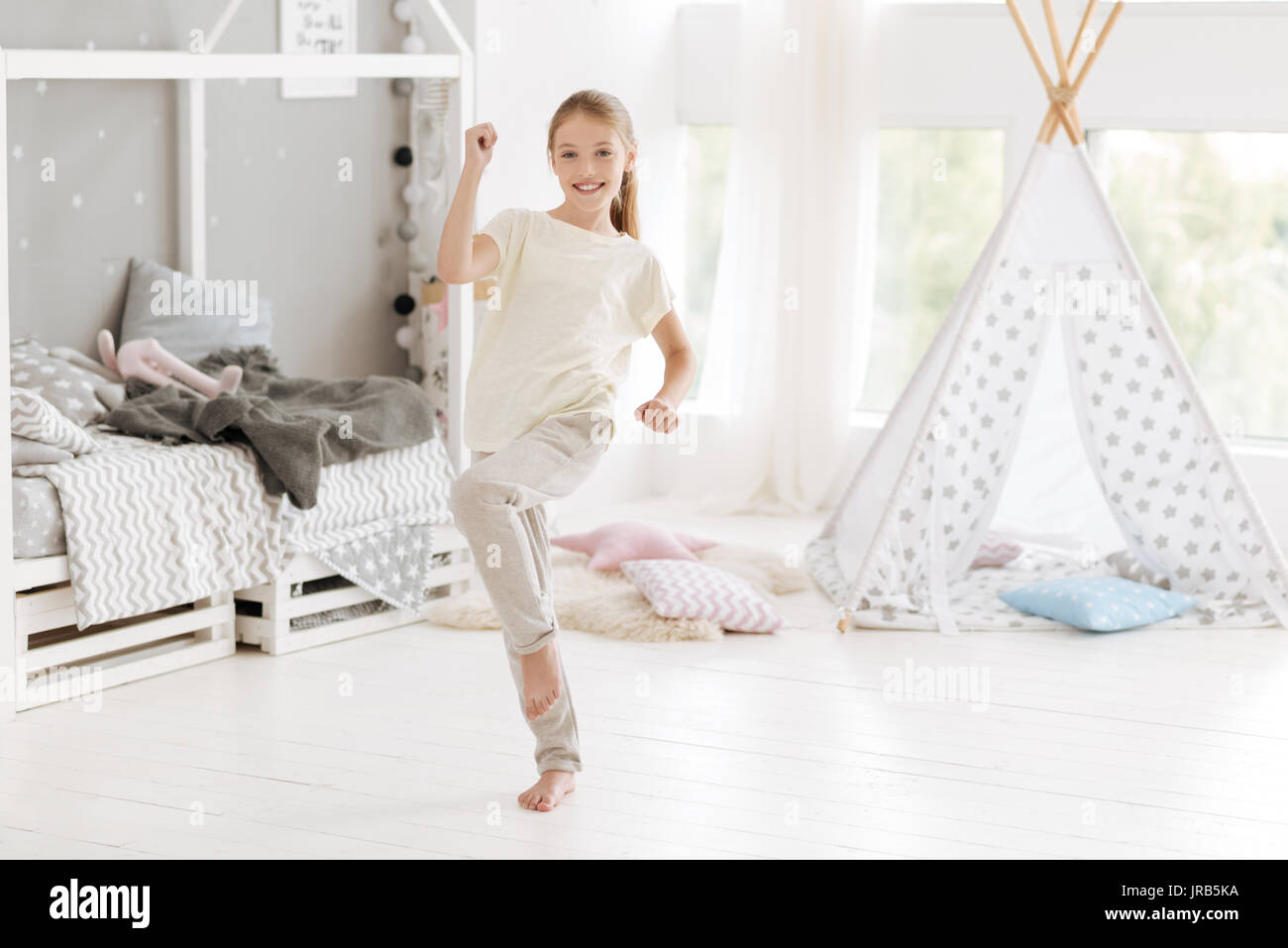 Positive mined kid playing tricks at home Stock Photo - Alamy