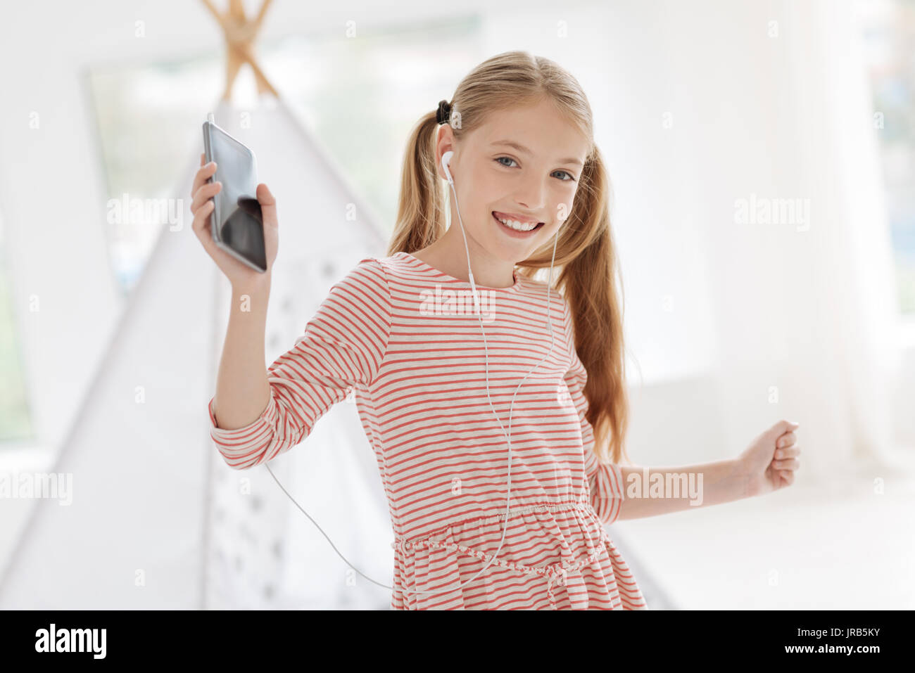 Active child dancing while listening to music Stock Photo - Alamy