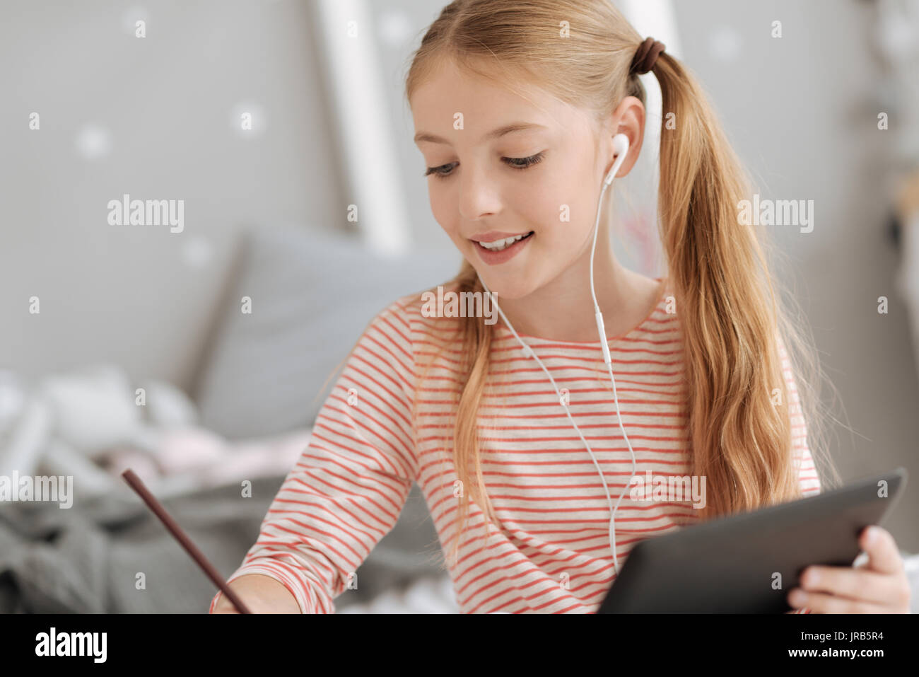 Happy child working and enjoying music Stock Photo - Alamy