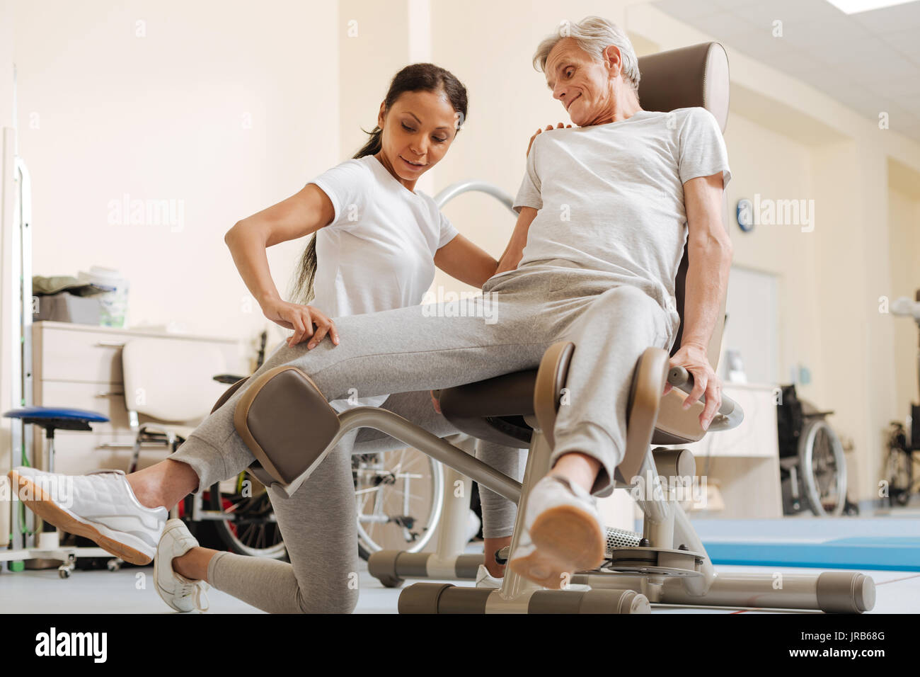 Strong woman helping her visitor in exercise Stock Photo - Alamy