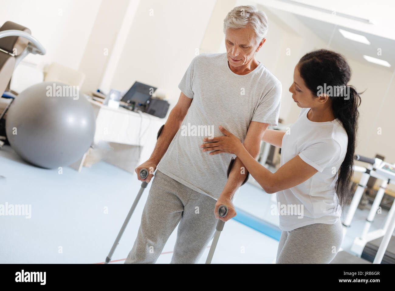 Concentrated grey-haired man bowing head Stock Photo - Alamy