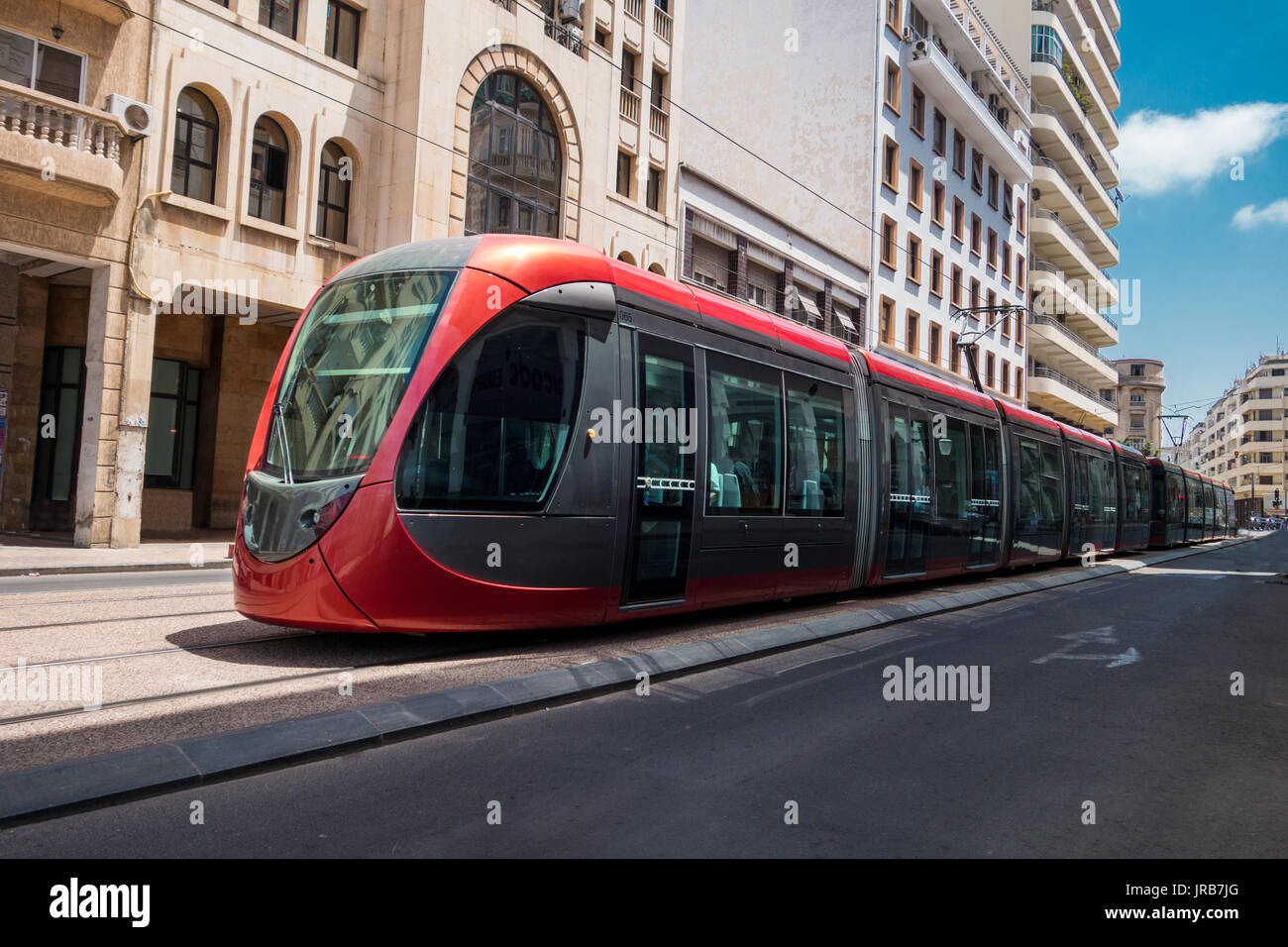 a tram passing on railways between old buildings - Casablanca - Morocco ...