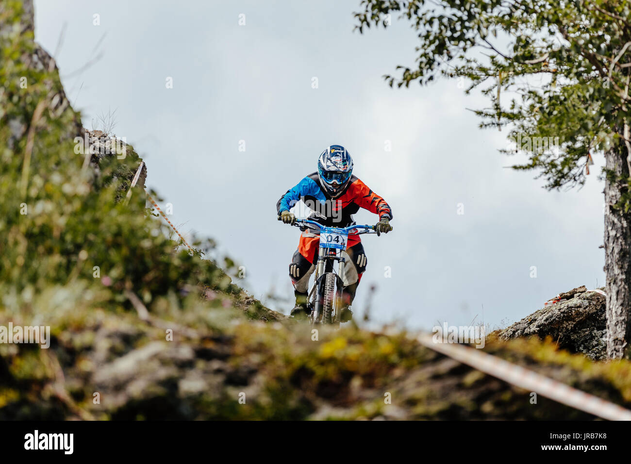 man rider downhill bicycle on a mountain trail during National ...