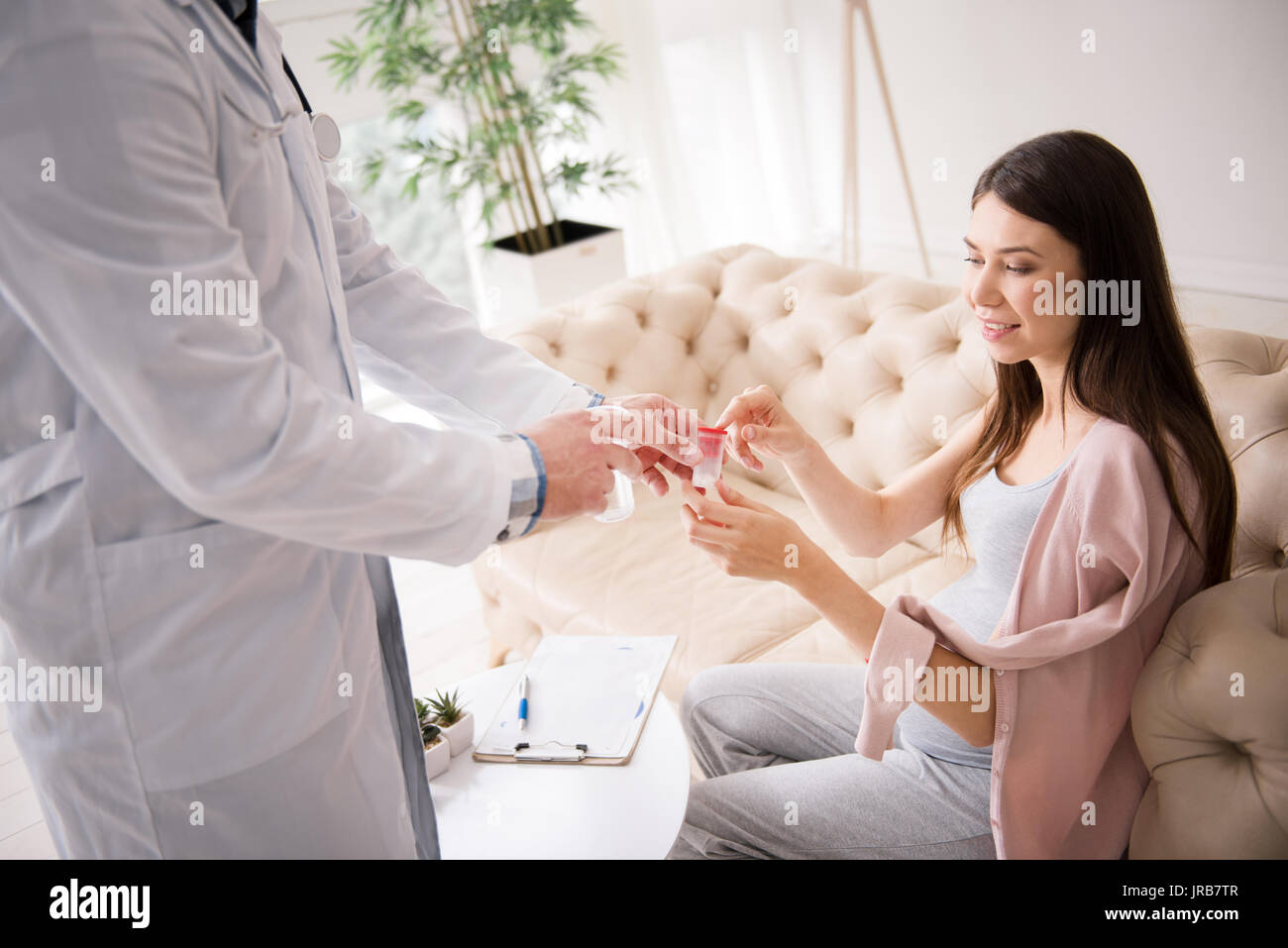 Attentive female person keeping smile on her face Stock Photo - Alamy
