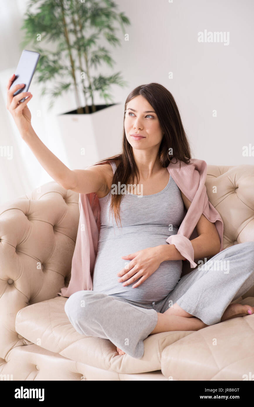 Serious woman posing like a model Stock Photo - Alamy