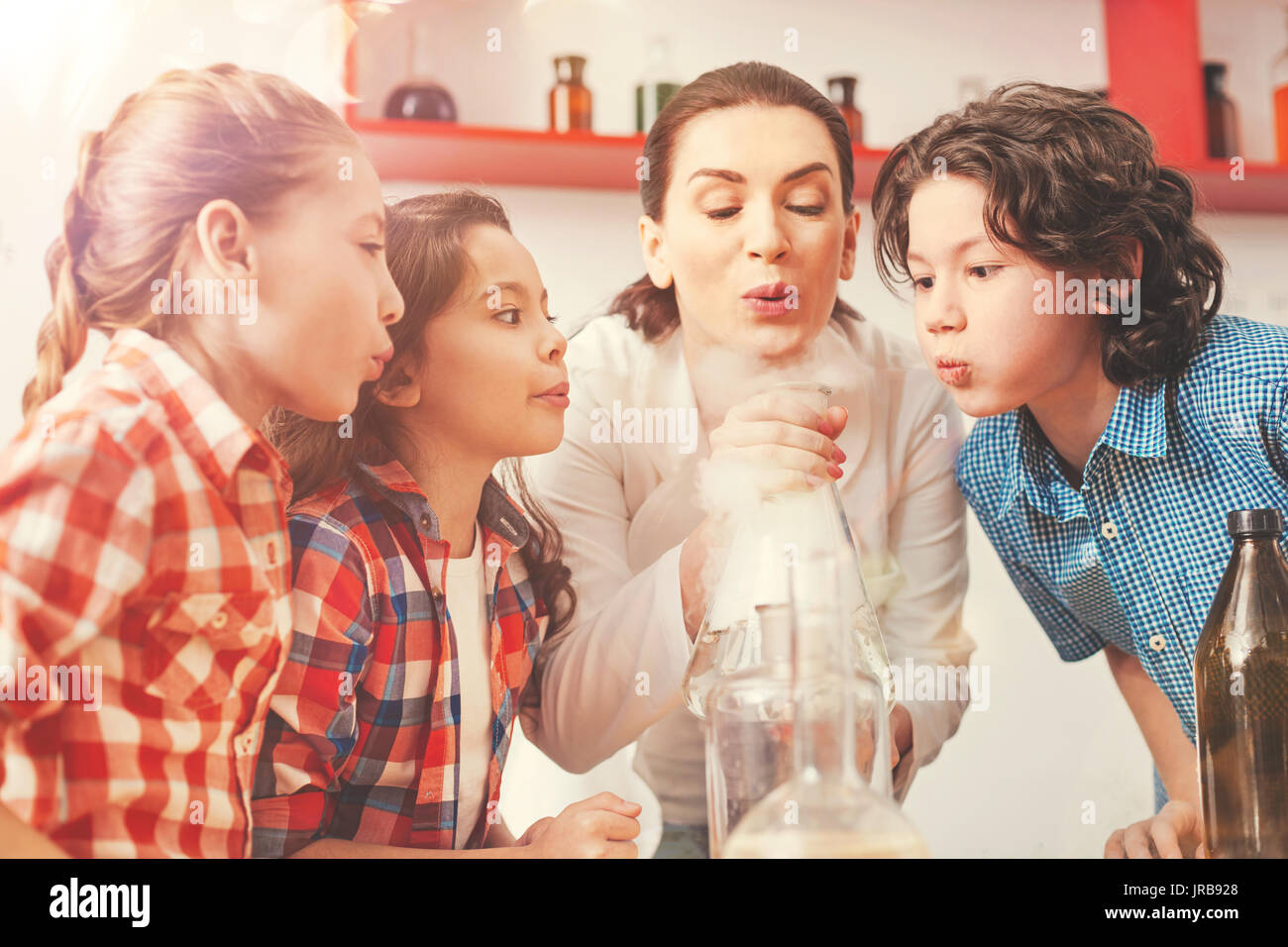 All children and their teacher looking at the reaction Stock Photo - Alamy