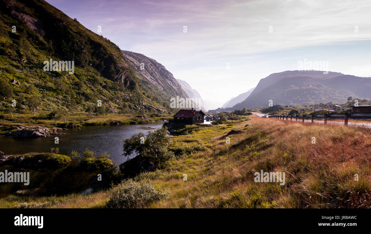 Scenic valley in Norway with traditional wooden house in the background ...