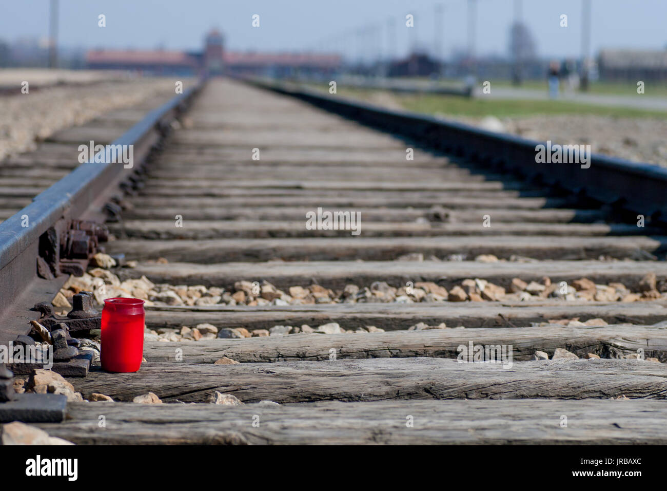 Candle of remembrance left on a train track in former Nazi ...