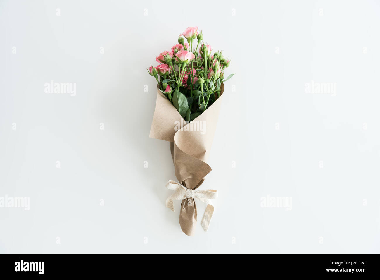 pink roses bouquet in kraft paper isolated on white with copy space ...