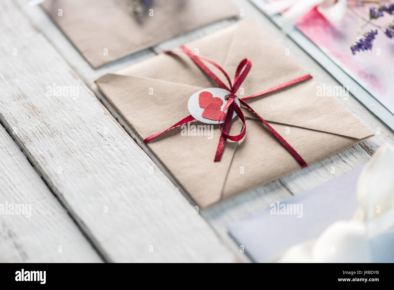 collection of envelopes or invitations on white wooden tabletop ...