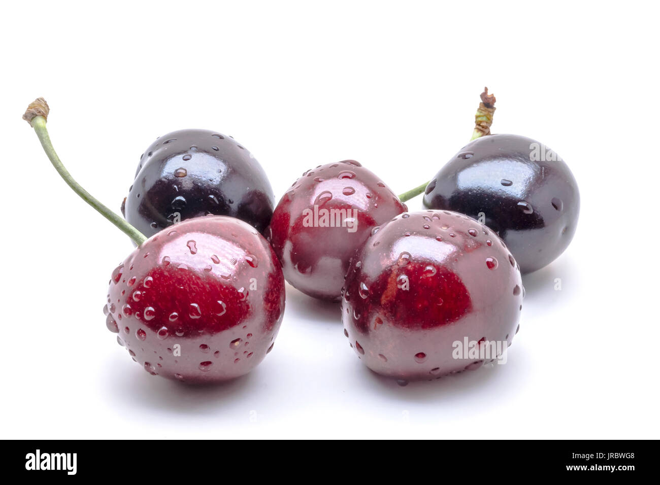 Few wet cherries berries isolated on white background Stock Photo - Alamy
