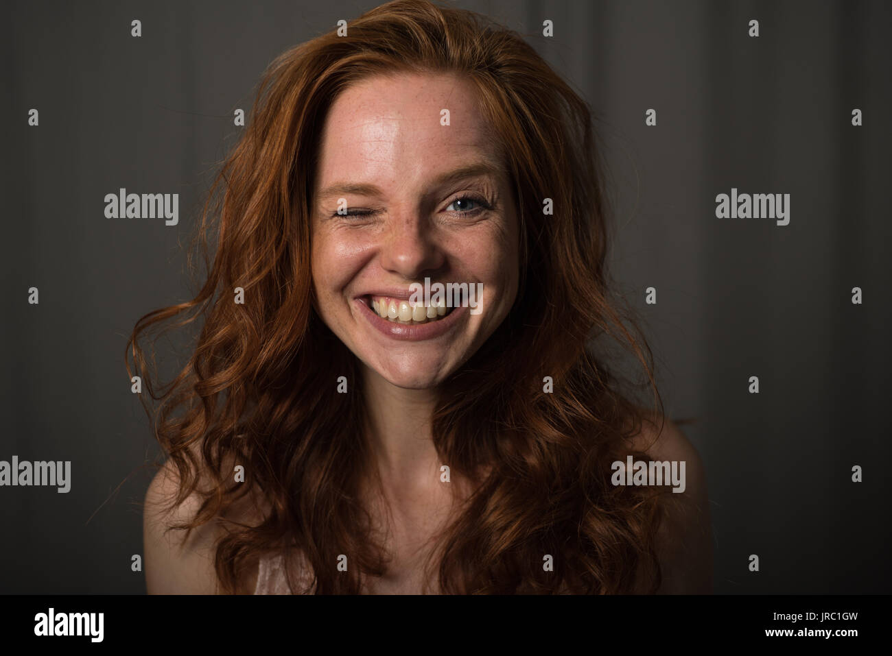 Woman winking eyes hi-res stock photography and images - Alamy