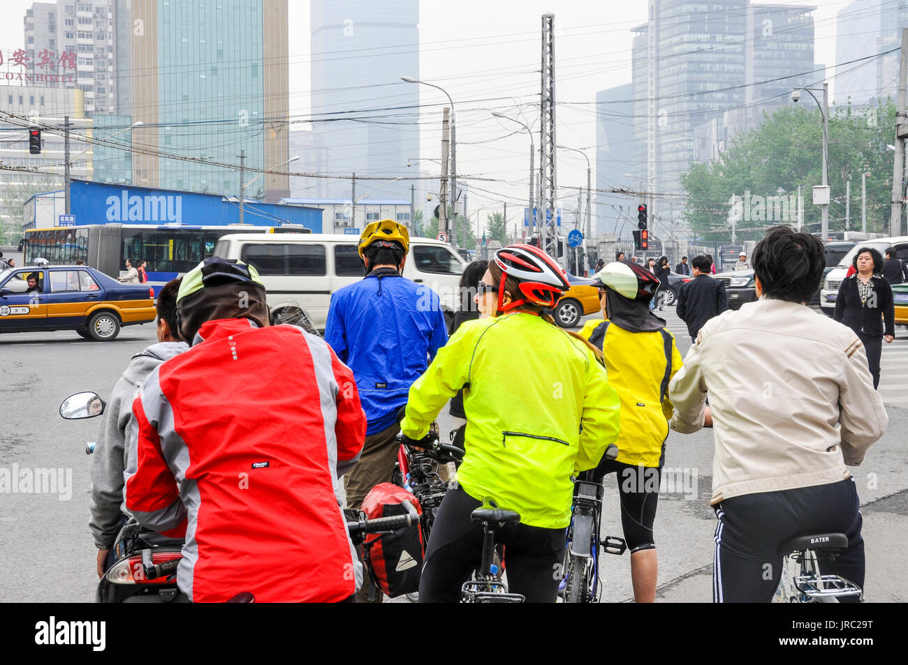 Touring Caucasian cyclists riding their bicycles in central Beijing ...
