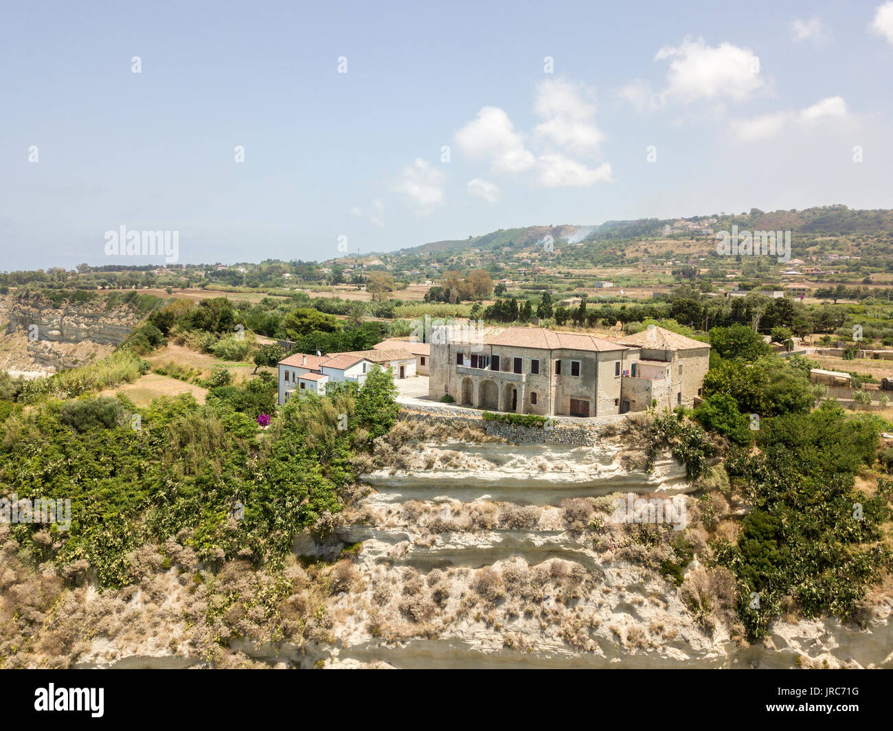 Aerial view of houses on the rock over a promontory overlooking the sea ...