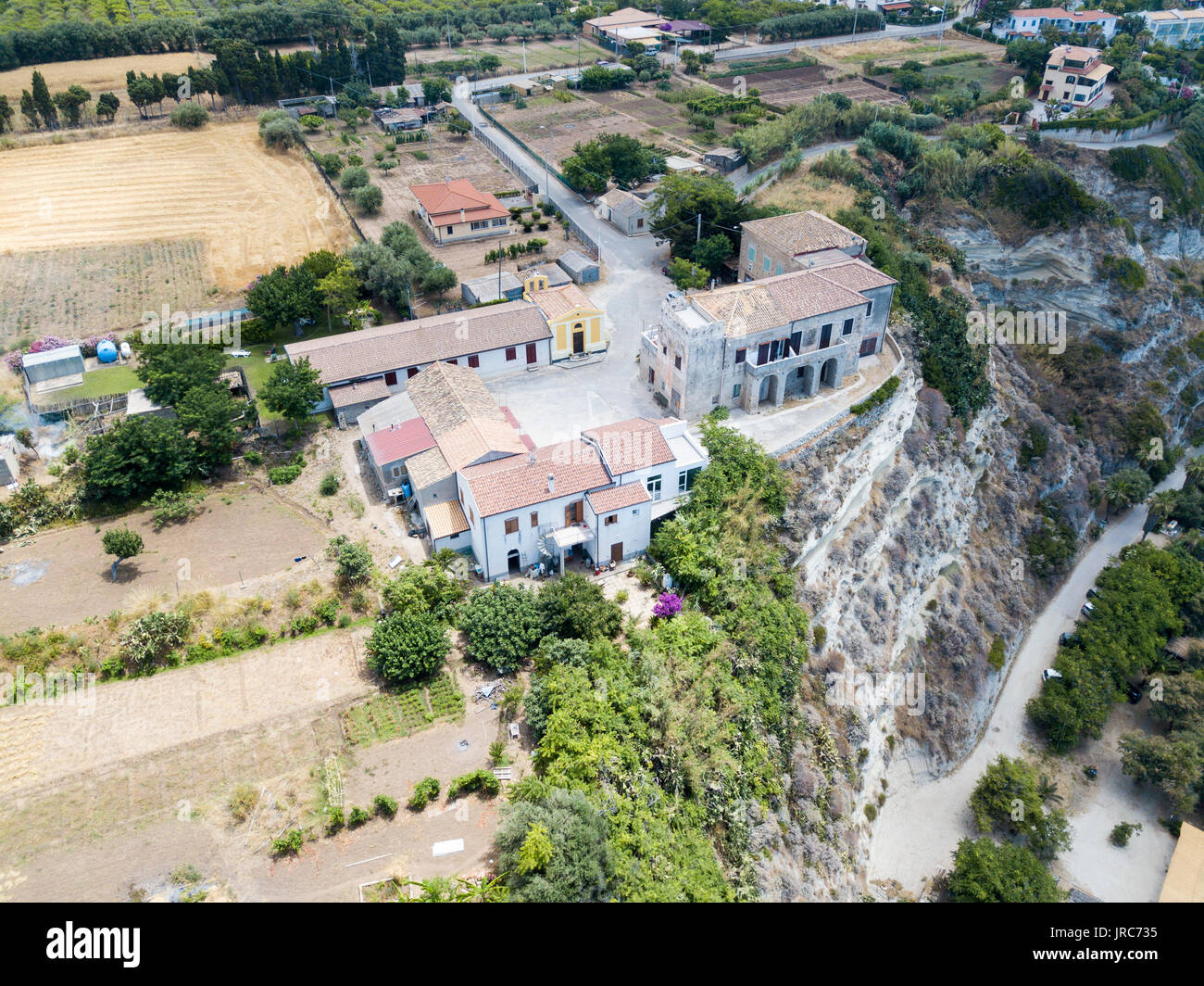 Aerial view of houses on the rock over a promontory overlooking the sea ...