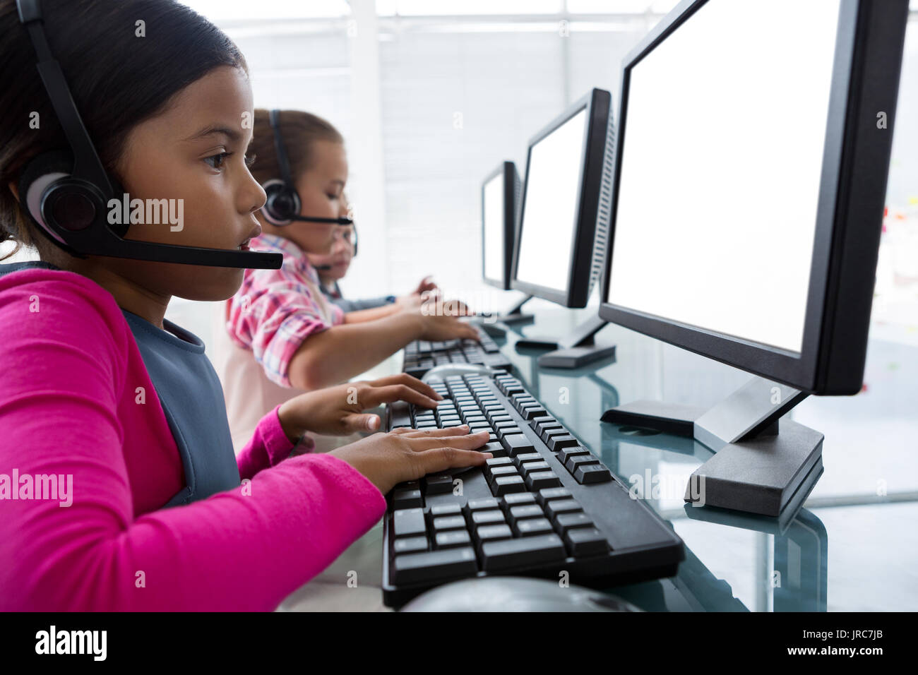 Kids using computer in office Stock Photo - Alamy