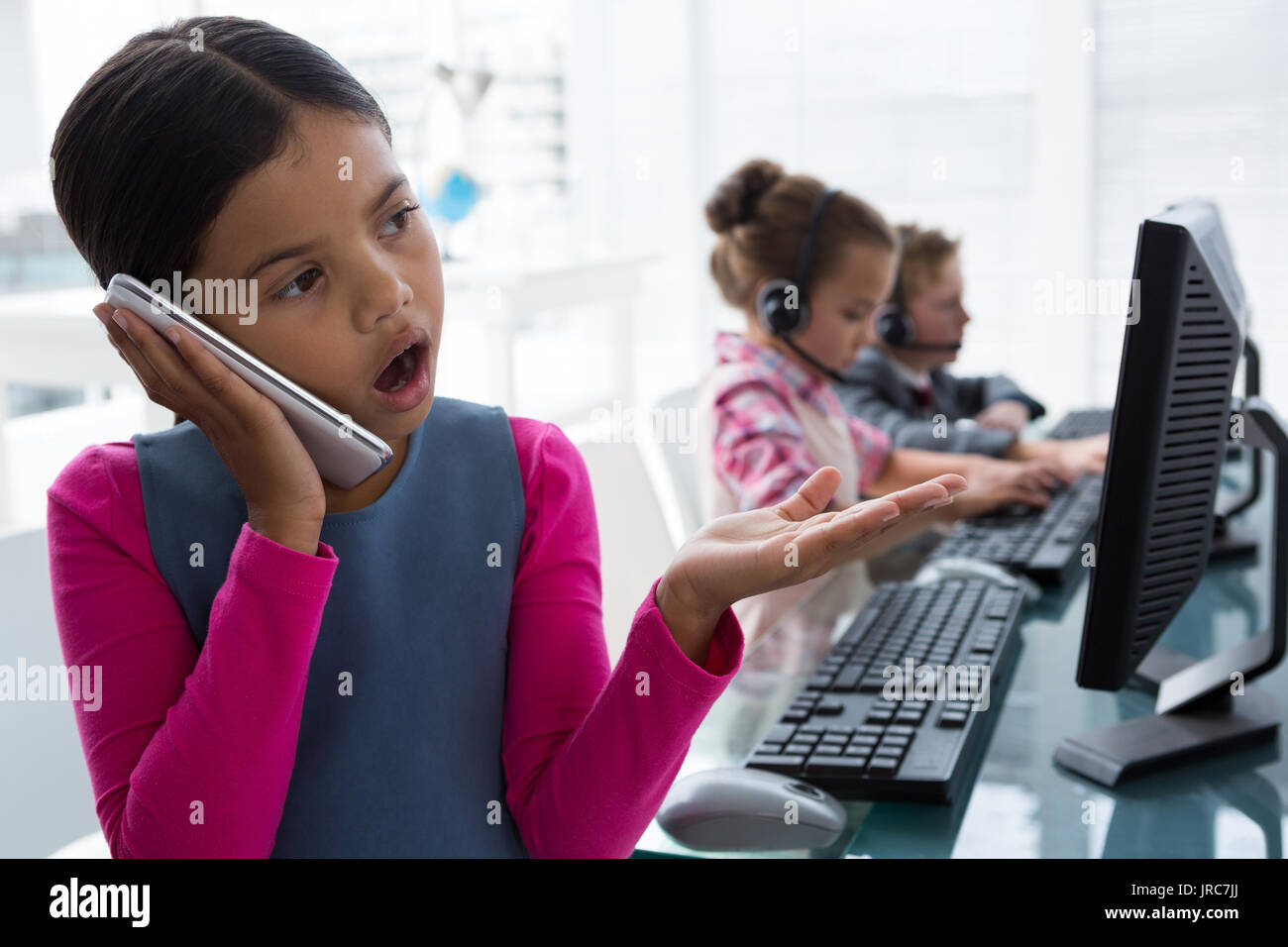 Kids using computer in office Stock Photo - Alamy