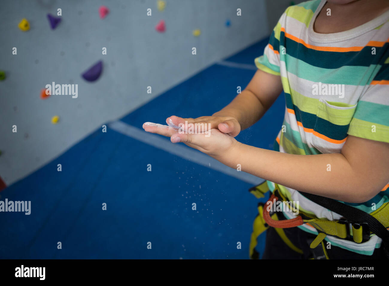 Mid-section of boy rubbing powder on hands in studio Stock Photo - Alamy