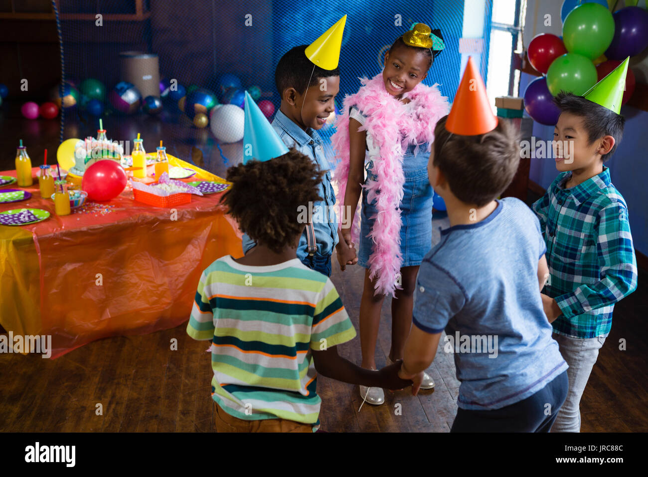 Children playing in room during birthday party Stock Photo - Alamy