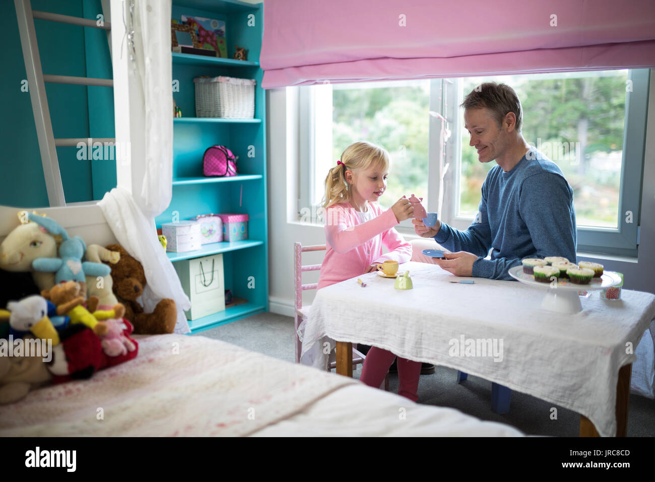 Playful girl pouring tea hi-res stock photography and images - Alamy