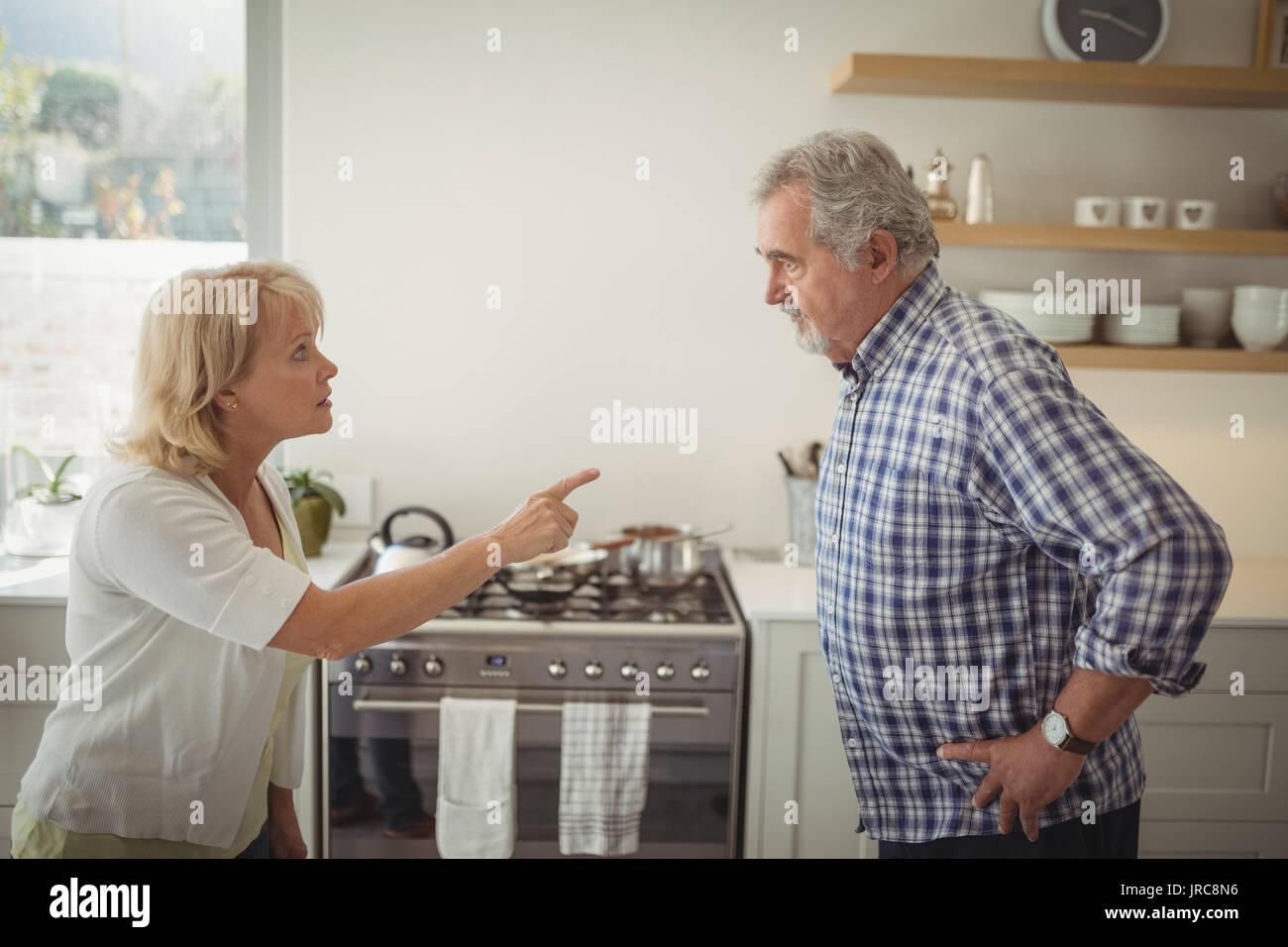 Senior couple arguing in kitchen at home Stock Photo - Alamy