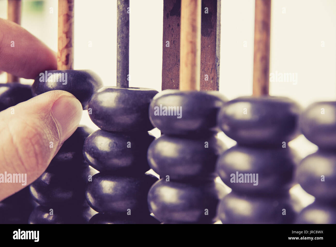 close up image of hand accounting with old abacus. financial concept ...