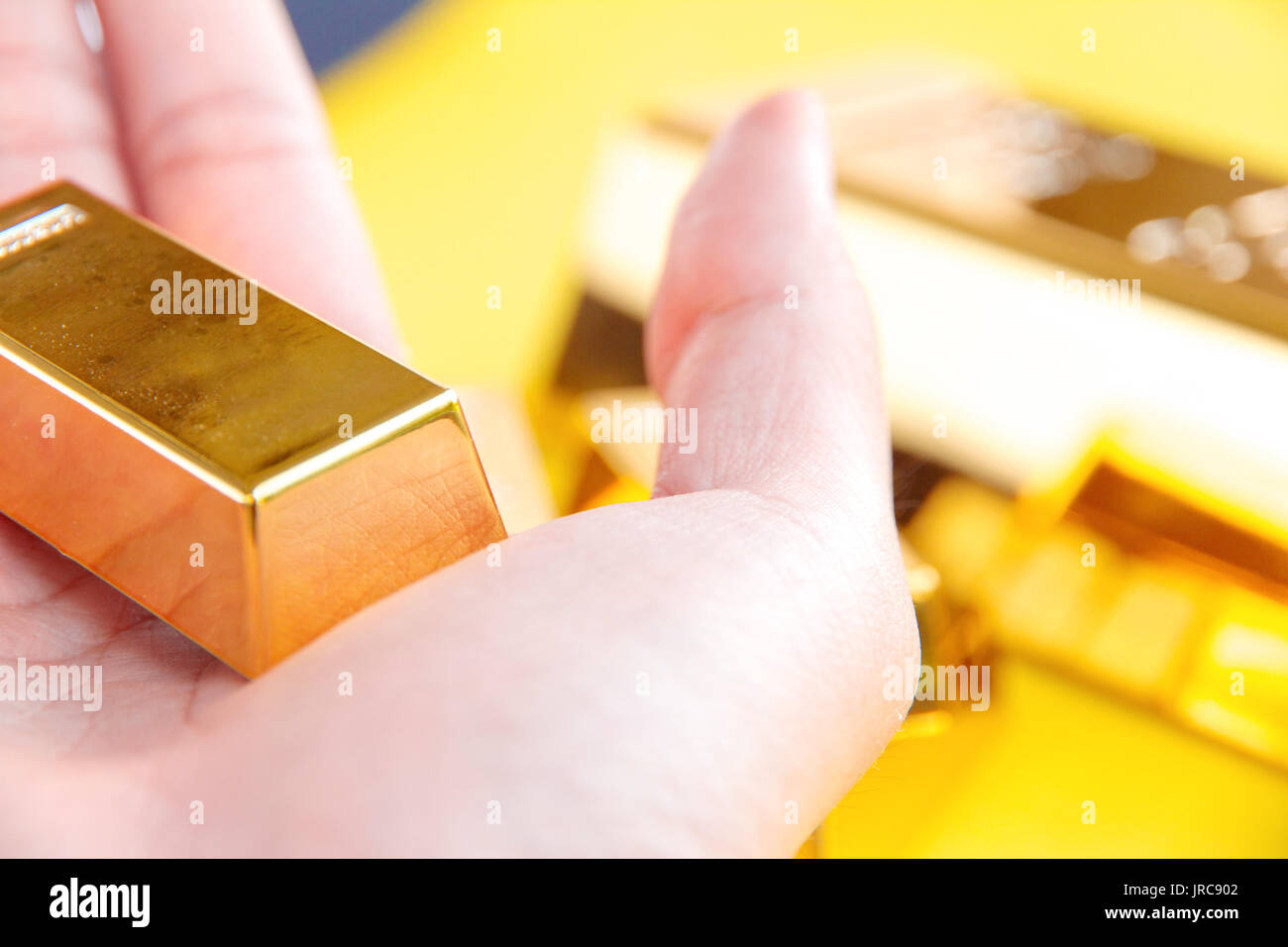 Hand hold gold bars Stock Photo - Alamy