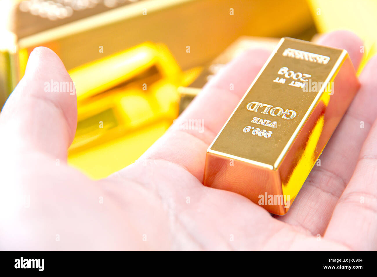 Hand hold gold bars Stock Photo - Alamy
