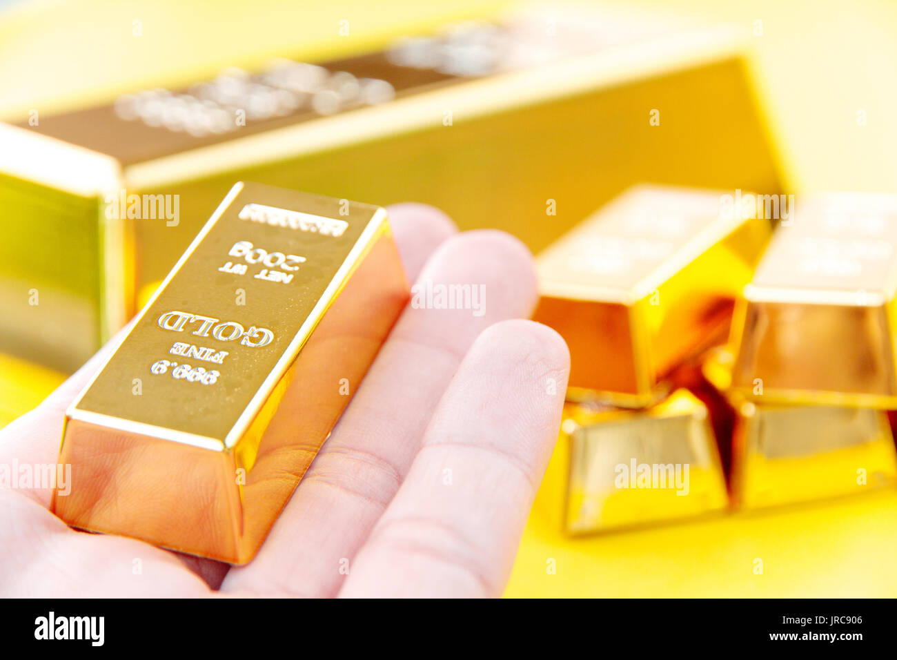 Hand hold gold bars Stock Photo - Alamy