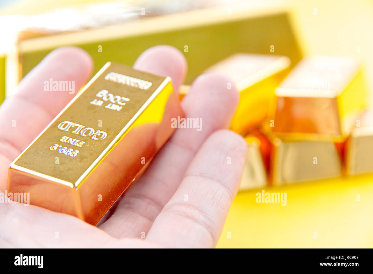 Hand hold gold bars Stock Photo - Alamy